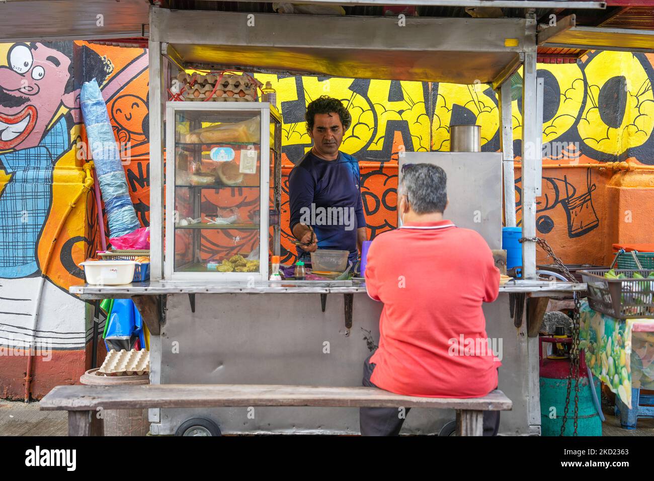 Some local people having breakfast at a stall at the Seremban Street ...