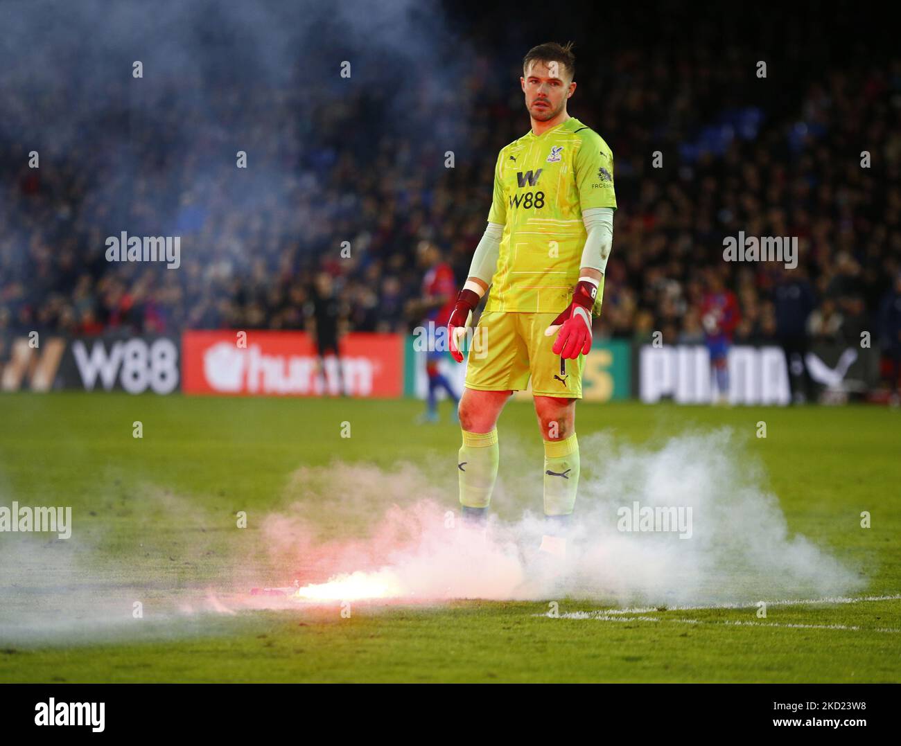 Crystal Palace goalkeeper Jack Butland standing next to a flare with ...
