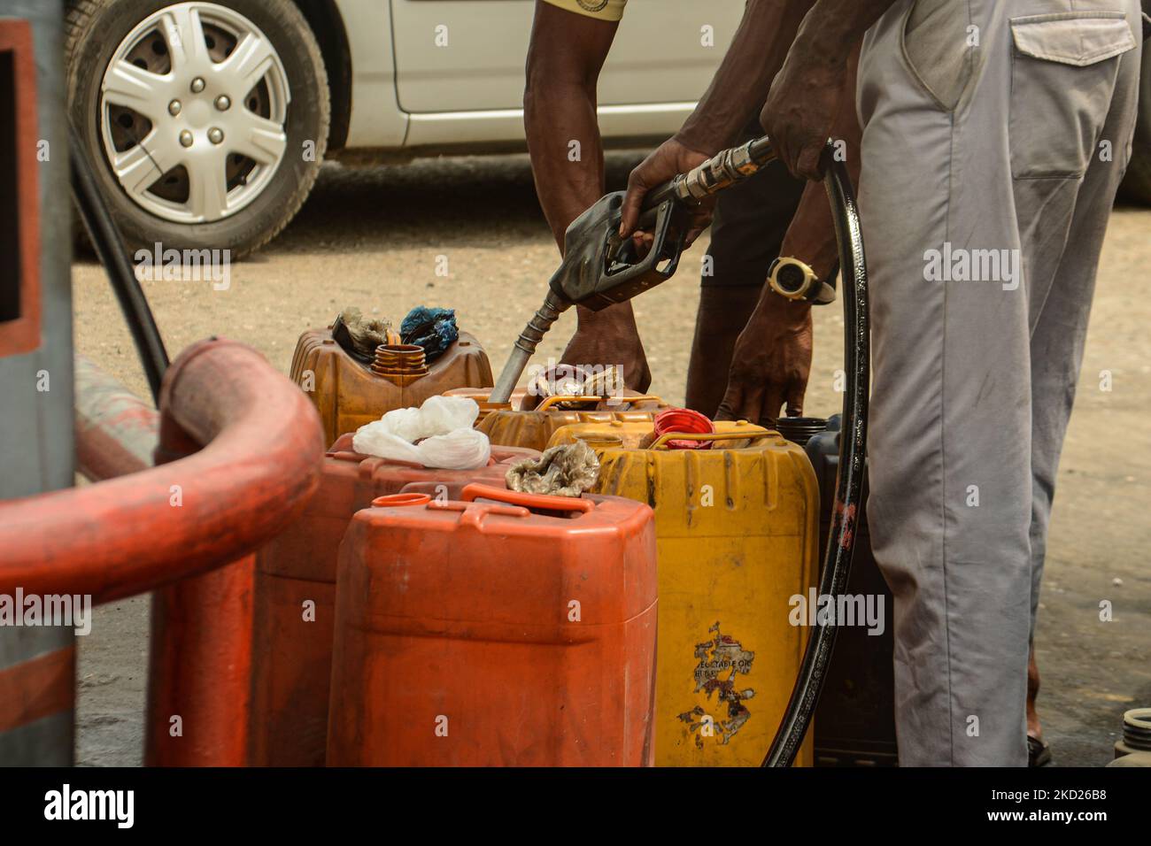 An attendant pumps fuel into jerrycans at FATGBEMS filling station in Lagos, Nigeria, 08 ...