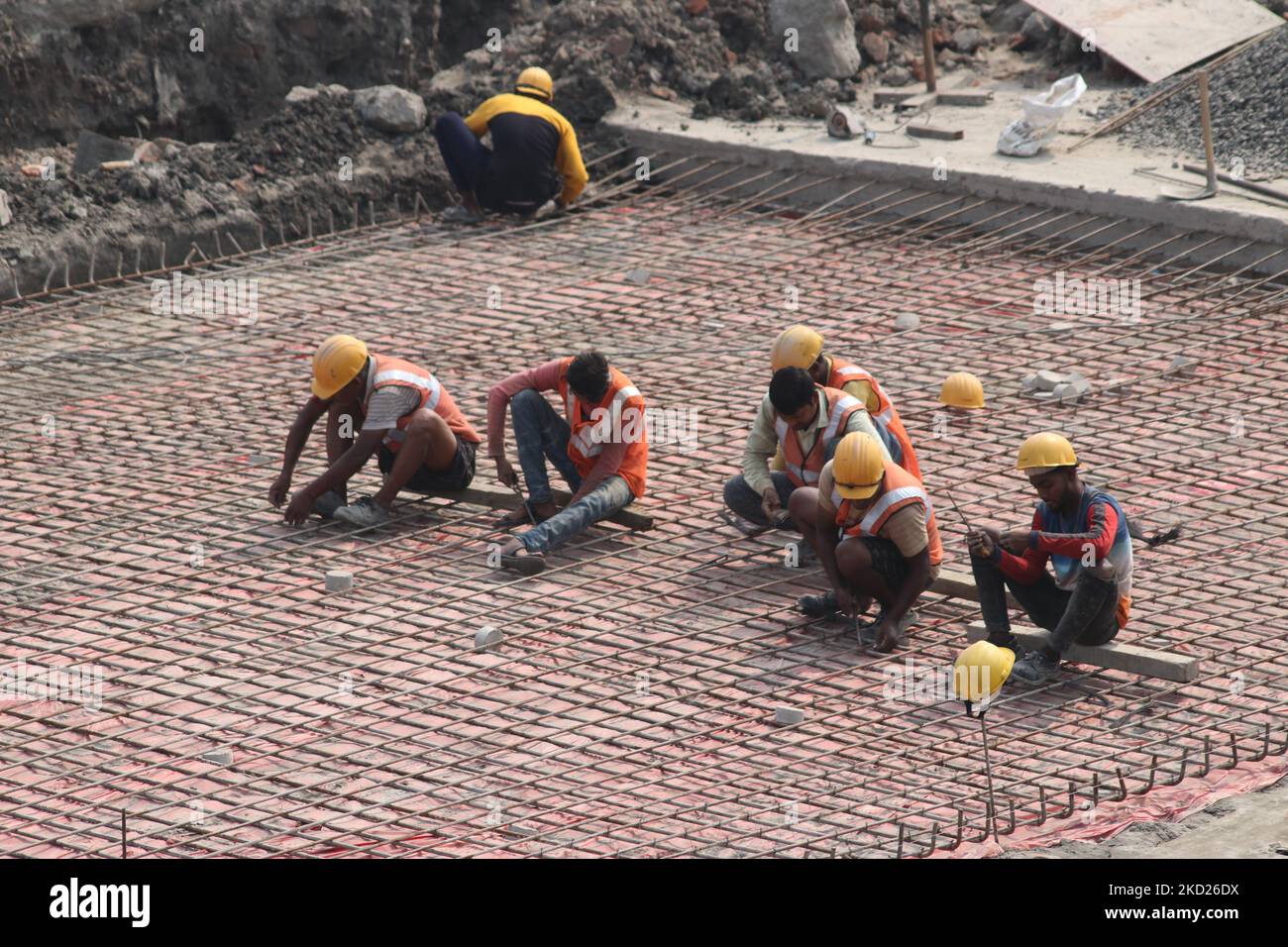 Indian Labourers work at the site of an under construction flyover in ...