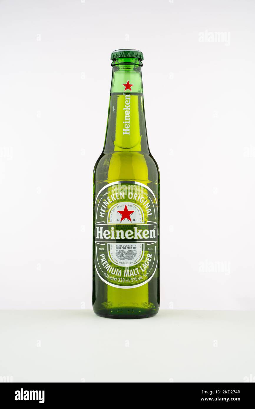A vertical shot of an unopened green bottle of Heineken beer isolated ...