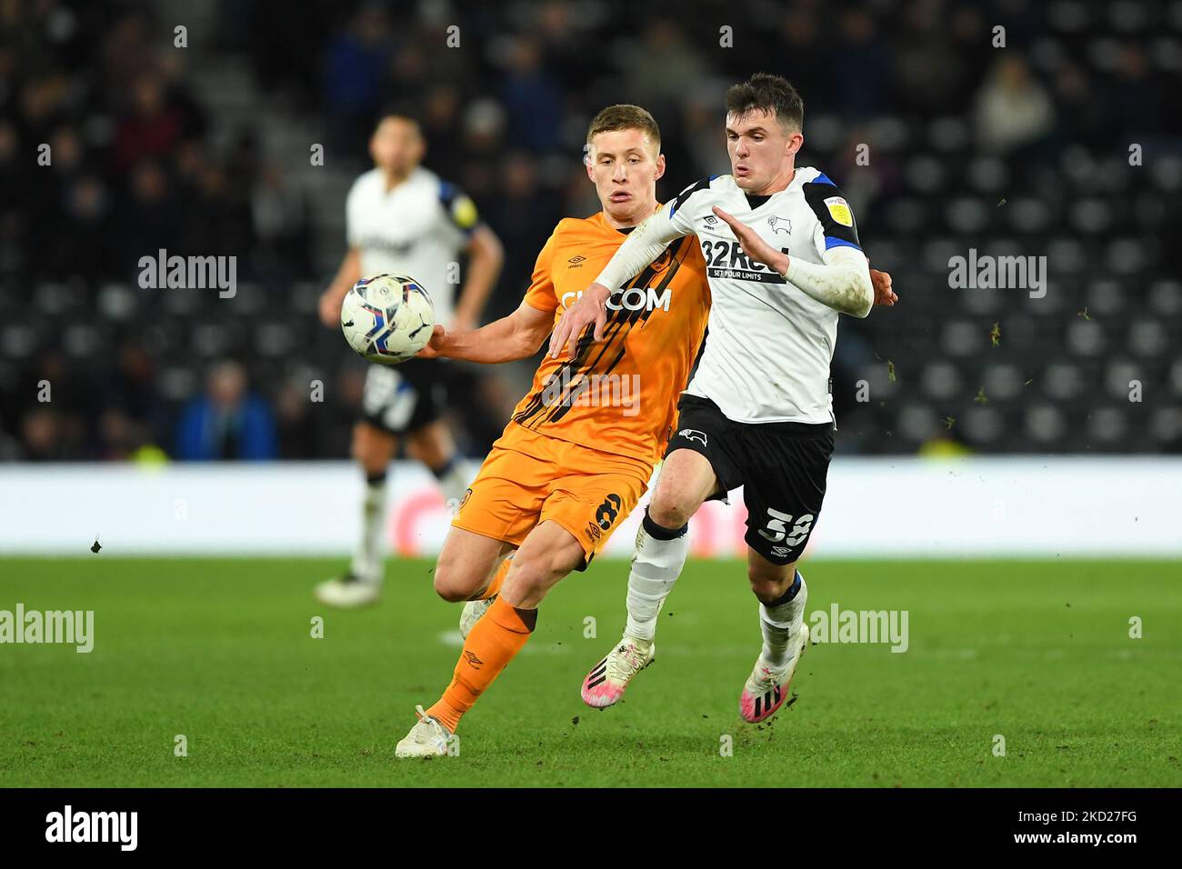 Jason Knight of Derby County competes for the ball with Greg Docherty ...