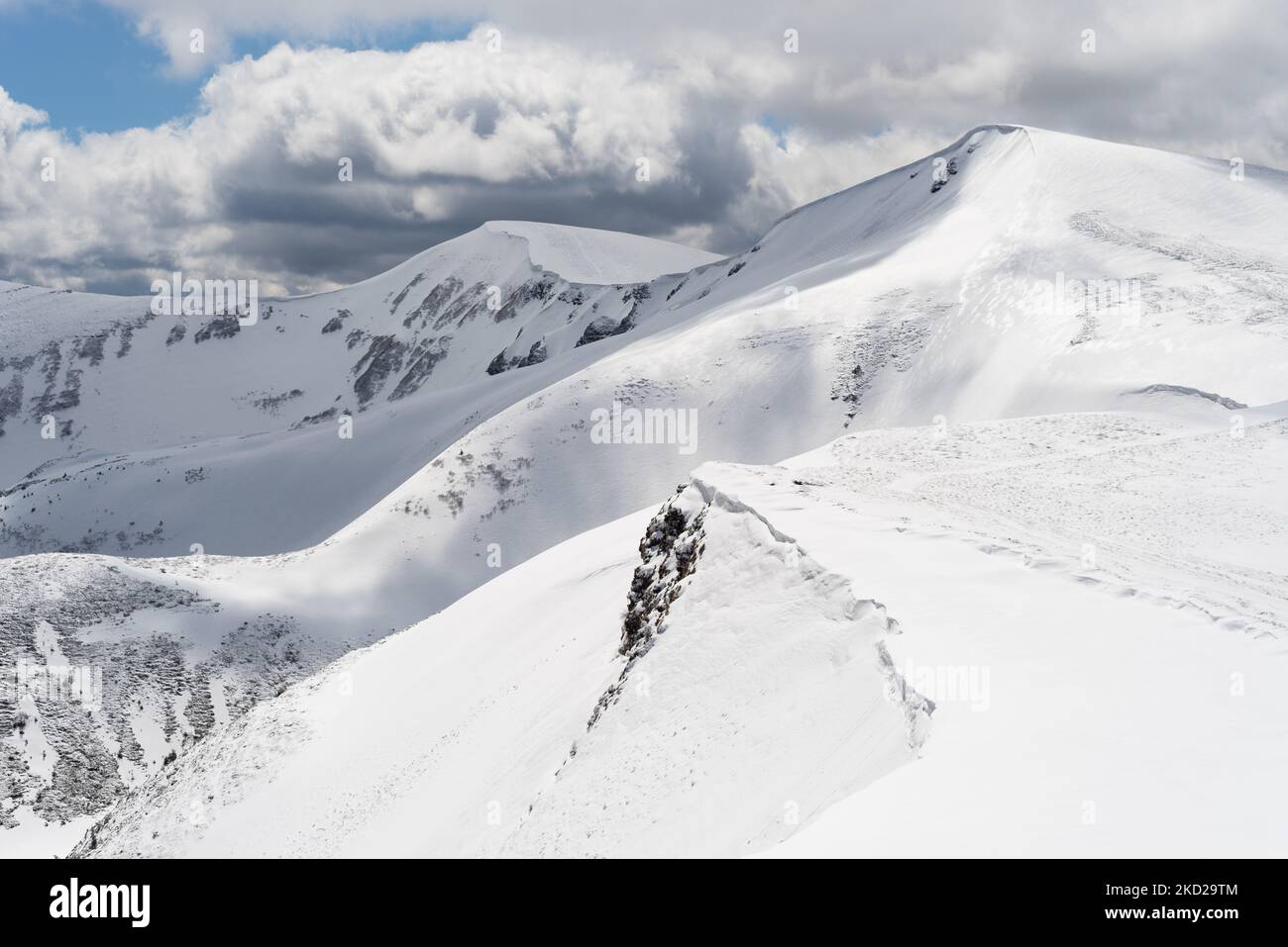 Mountain winter landscape with snow capped peaks Stock Photo - Alamy