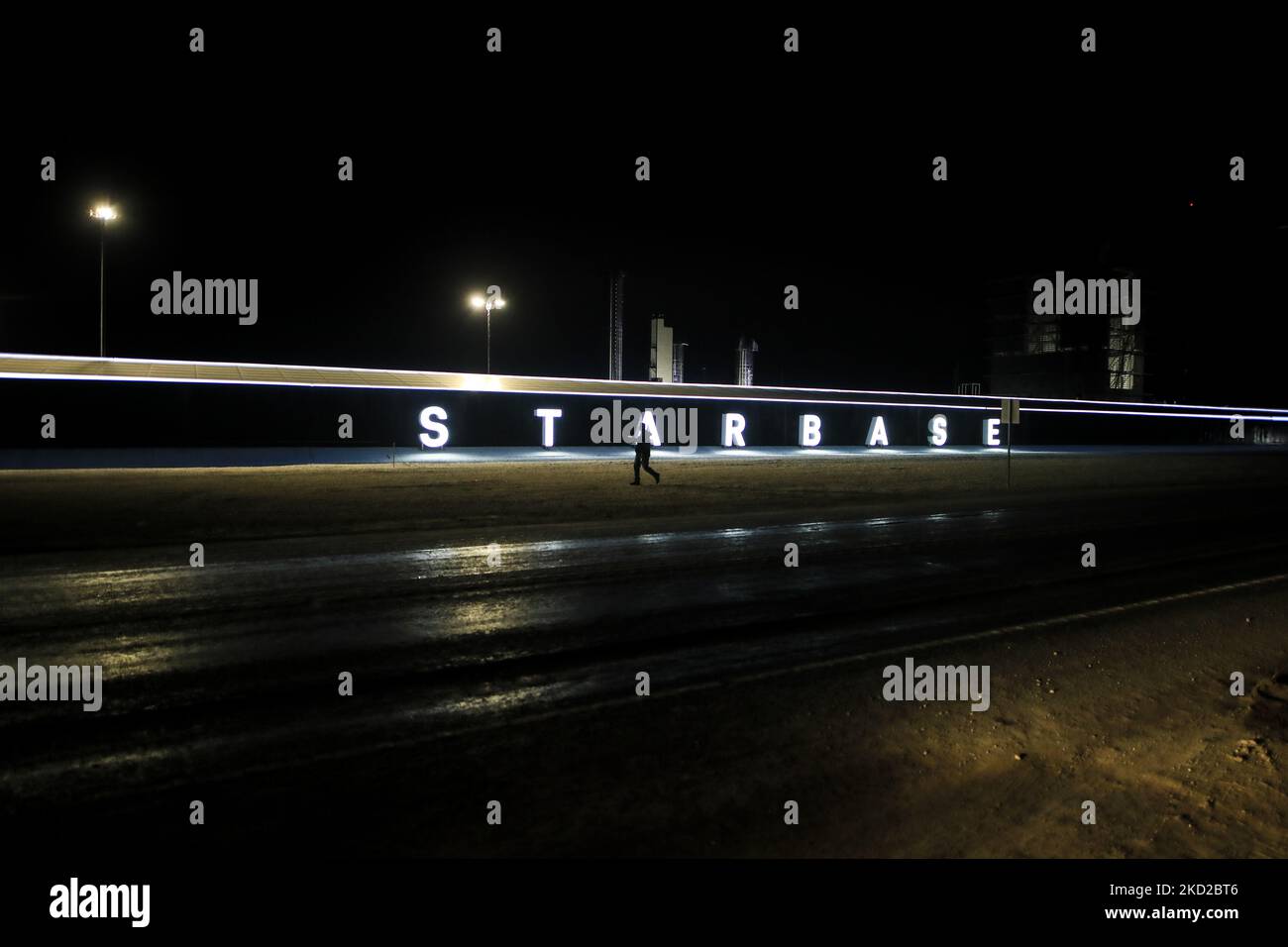 A man walks past the Starbase sign at SpaceX's South Texas campus late ...
