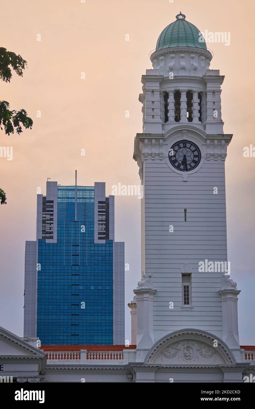 Old clock tower in the foreground on the right, standing in contrast to ...