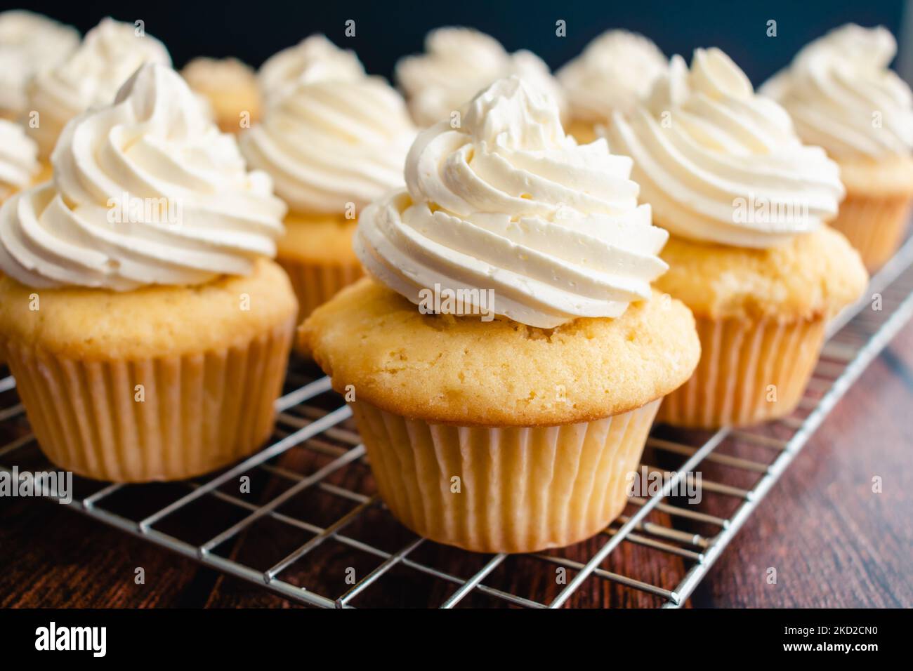 Homemade Vanilla Cupcakes on Wire Cooking Racks: Side view of vanilla ...