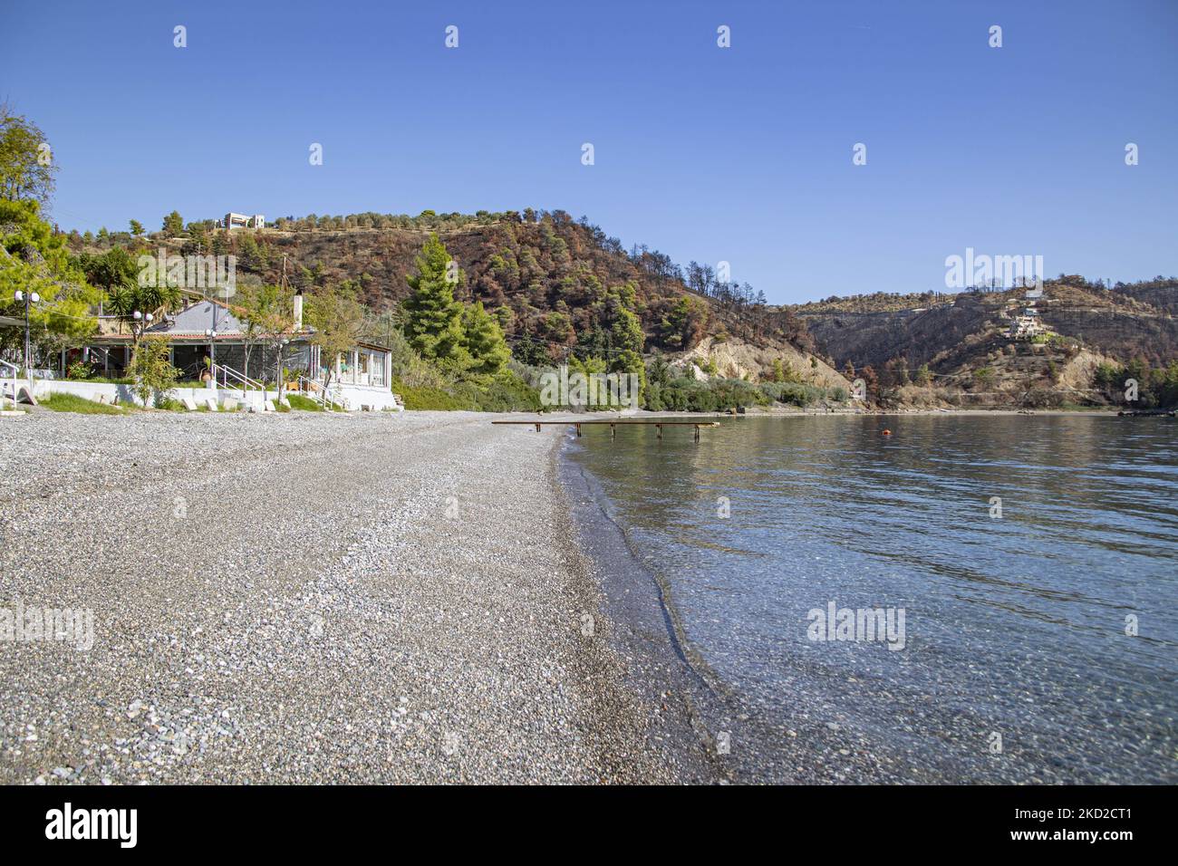 Sunny day and calm sea at Kohili beach, with pebble while a woman ...