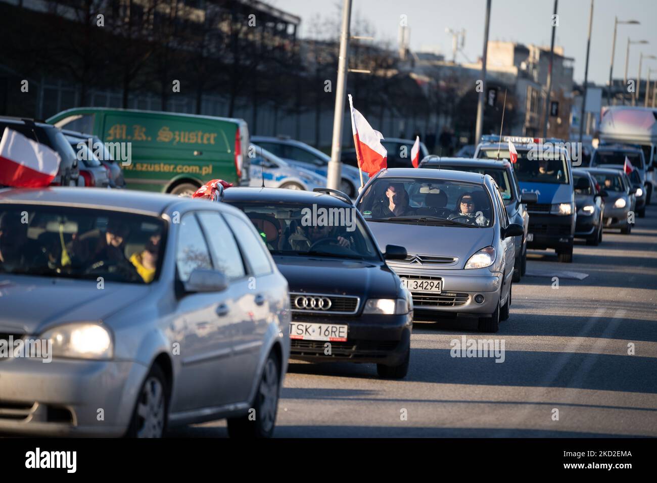 Several trucks and a dozen passenger cars gathered in the parking lot ...
