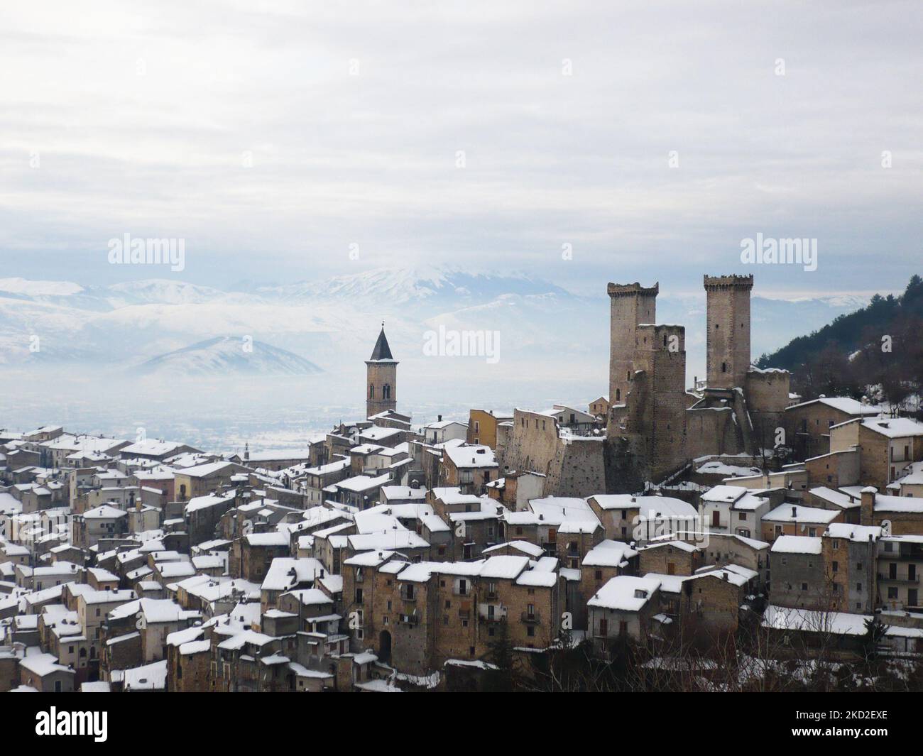 Snowy view of Pacentro and the Caldora or Cantelmo castle that ...