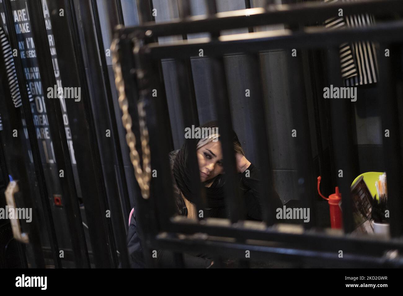 An Iranian woman looks on as she sits at a cell in the CELL-16 fast ...