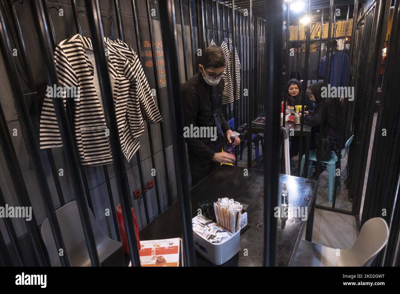 An Iranian waiter disinfectant a table at a cell in the CELL-16 fast ...