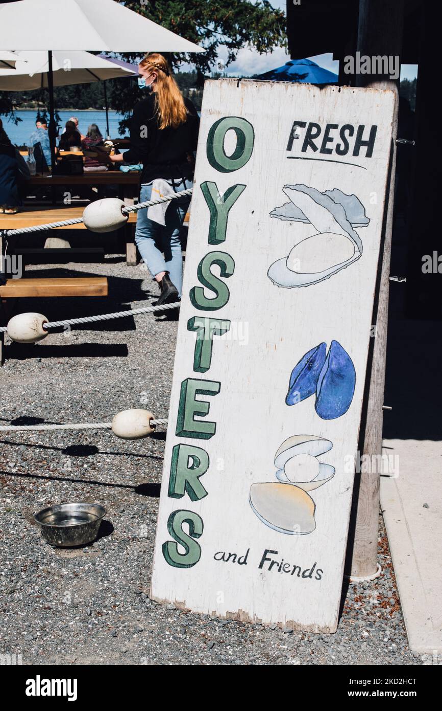 Fresh oysters sandwich board sign outdoors at restaurant, summertime ...