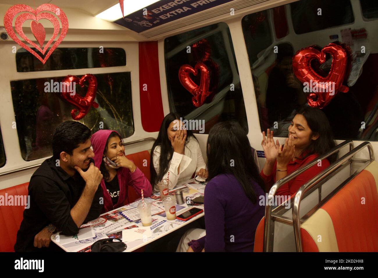 People enjoy food inside a double-decker dining bus restaurant ...