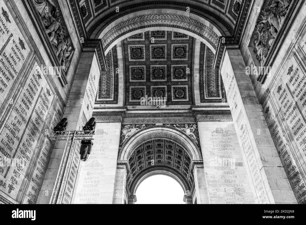 A grayscale of the architectural masterpiece of the Arc de Triomphe in Paris with detailed ...