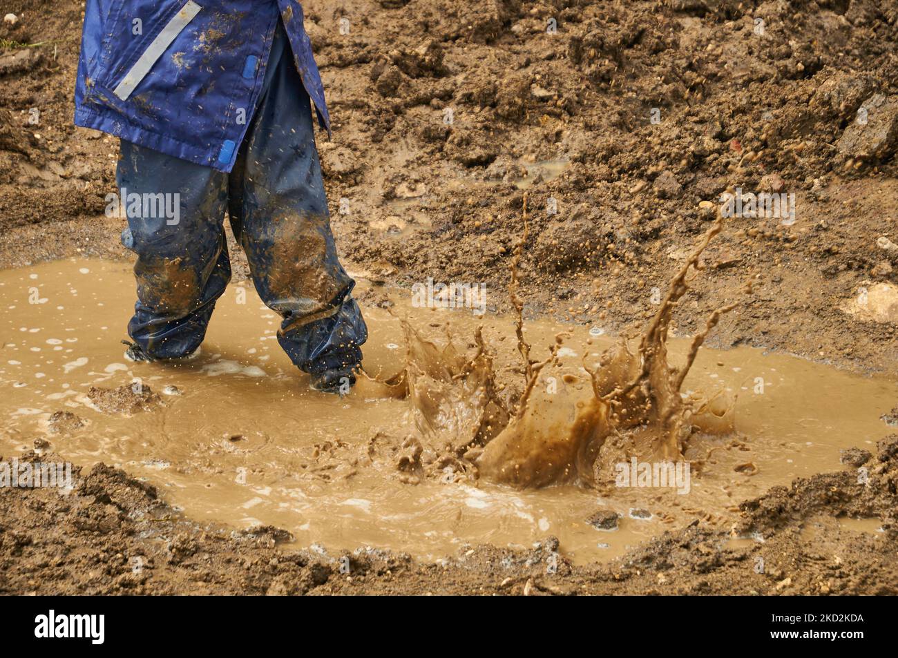 A person on muddy ground after the rain Stock Photo - Alamy