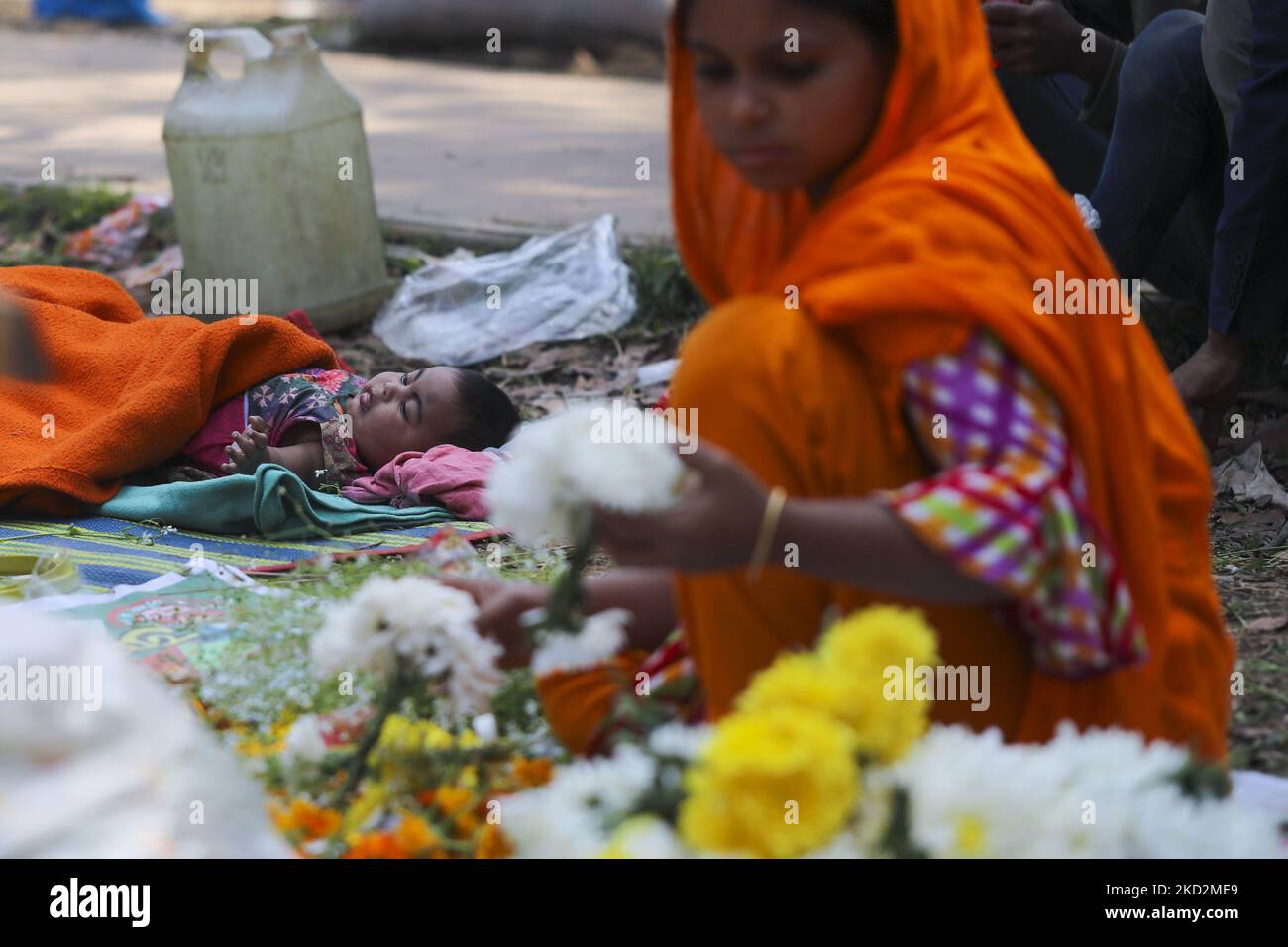 A four month baby seen while her mother is selling flower celebrate the ...