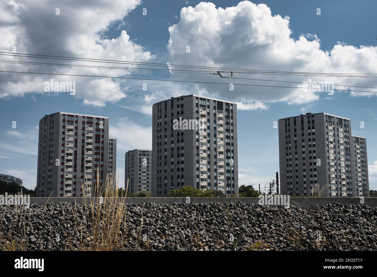 A row of duplicate residential apartments in a city area under a blue ...