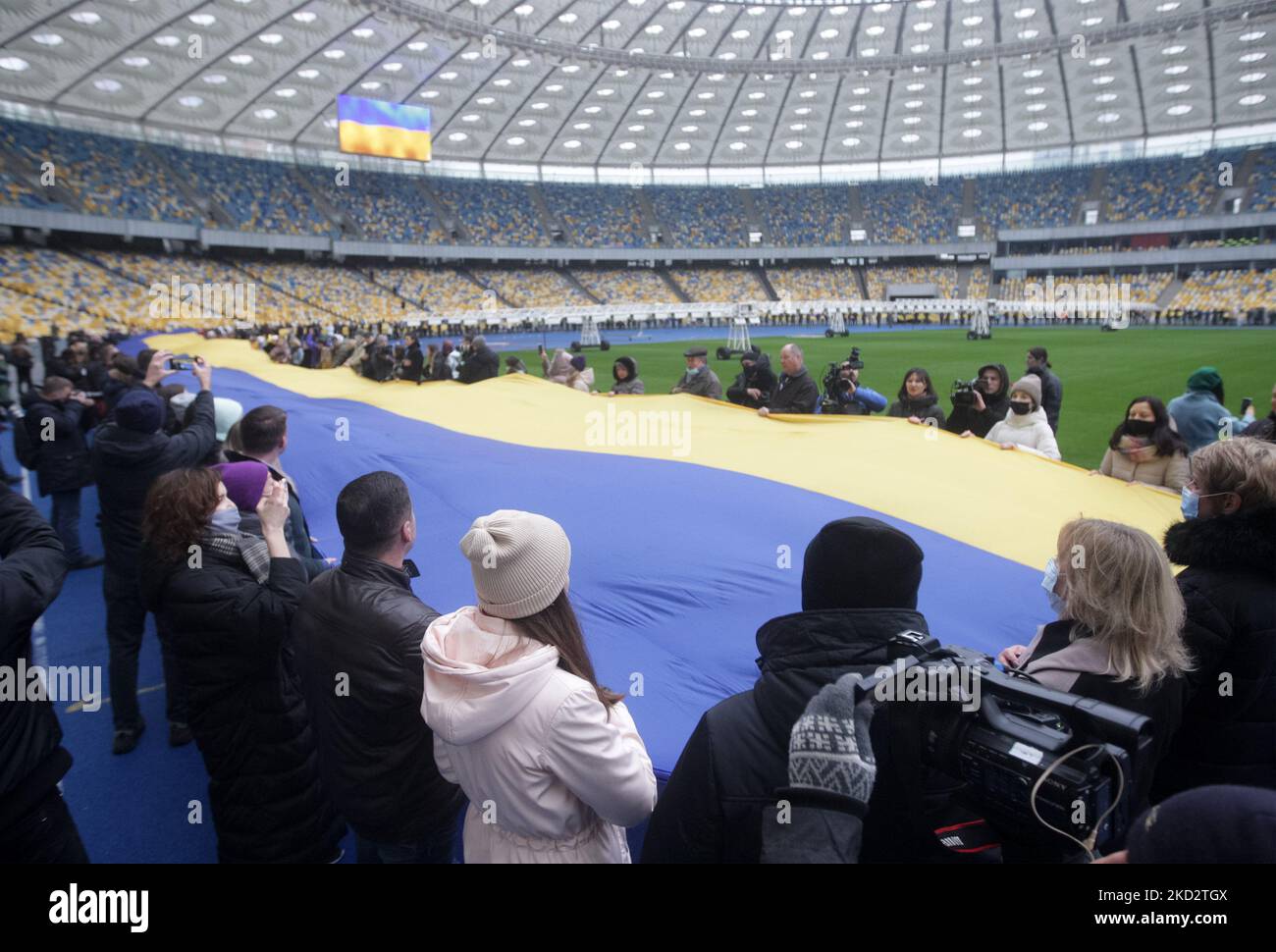 Ukrainians carry a huge national flag during the celebration of the Day ...