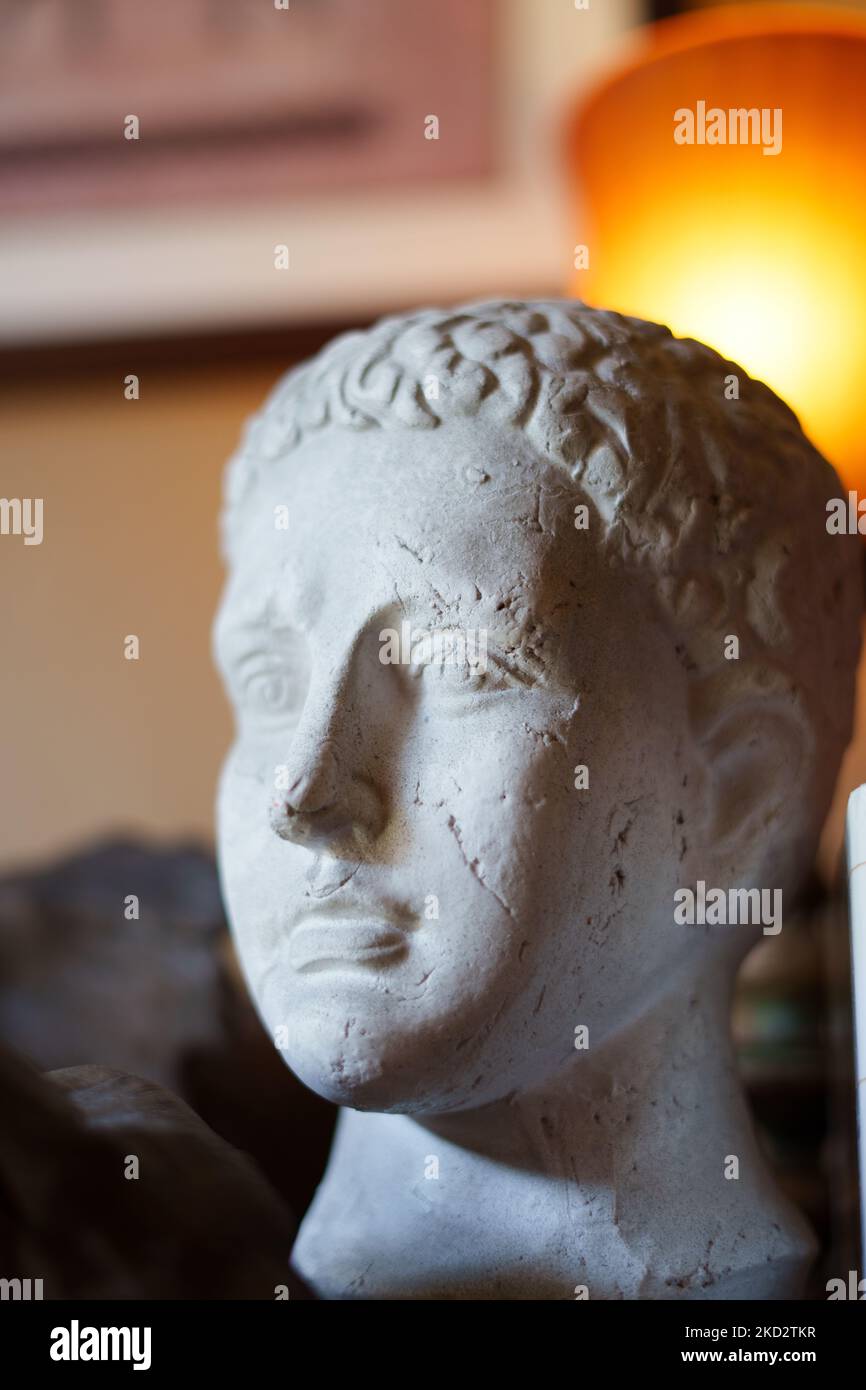 A vertical closeup of a small bust of man on the desk Stock Photo - Alamy