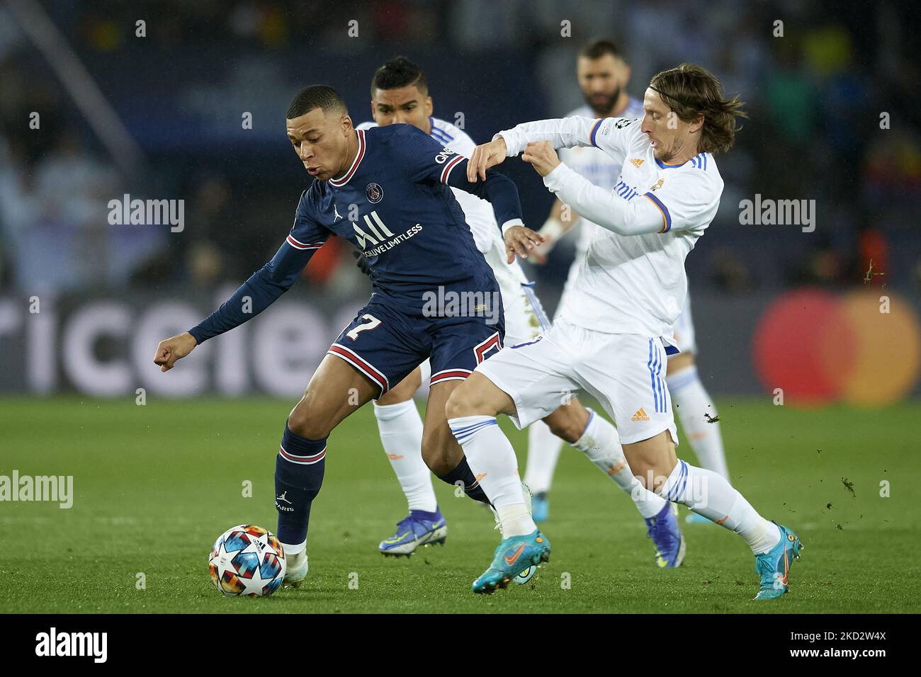 Kylian Mbappe of PSG and Luka Modric of Real Madrid compete for the ...