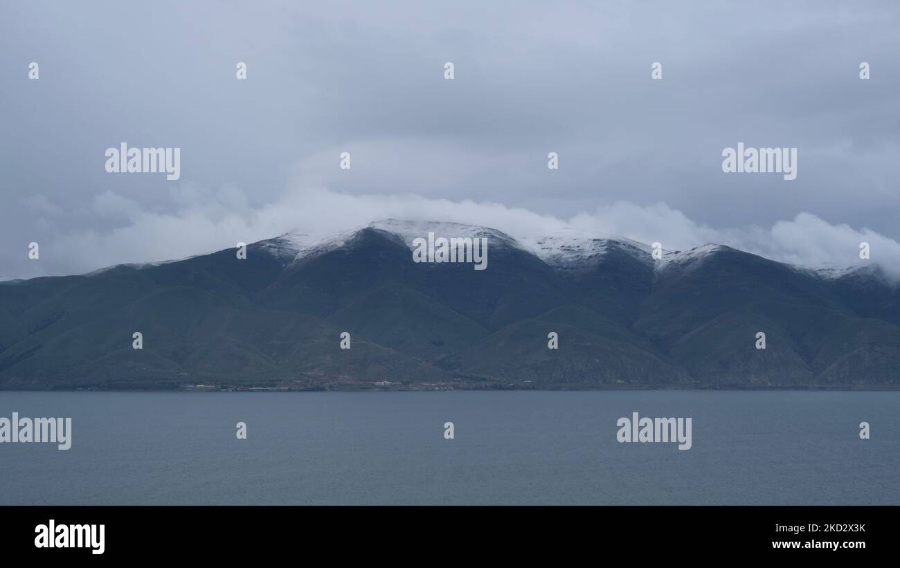 A scenic shot of the Geghama mountains in the background of the lake ...