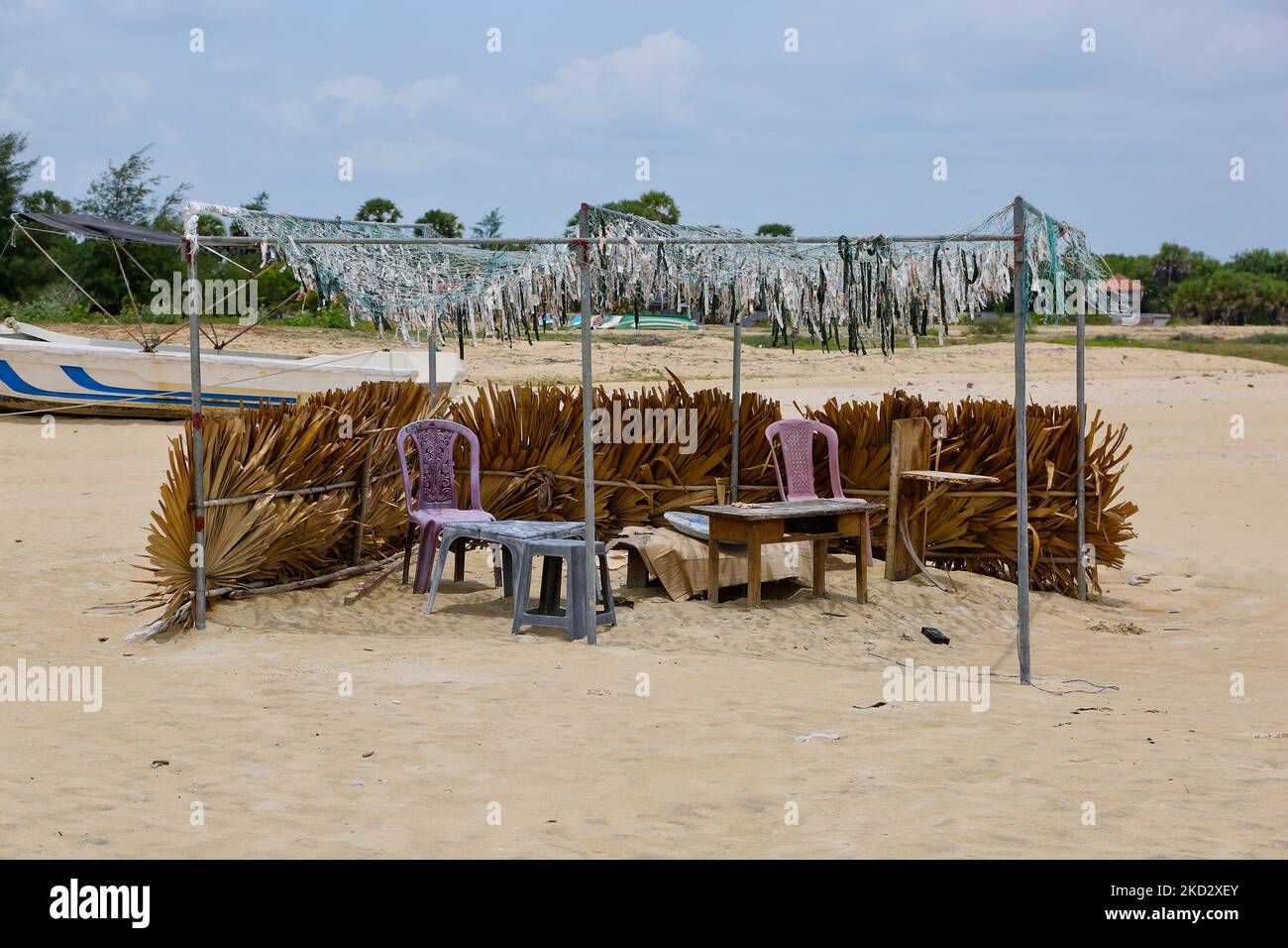 Small enclosure made from old fishing nets and palm leaves used by ...