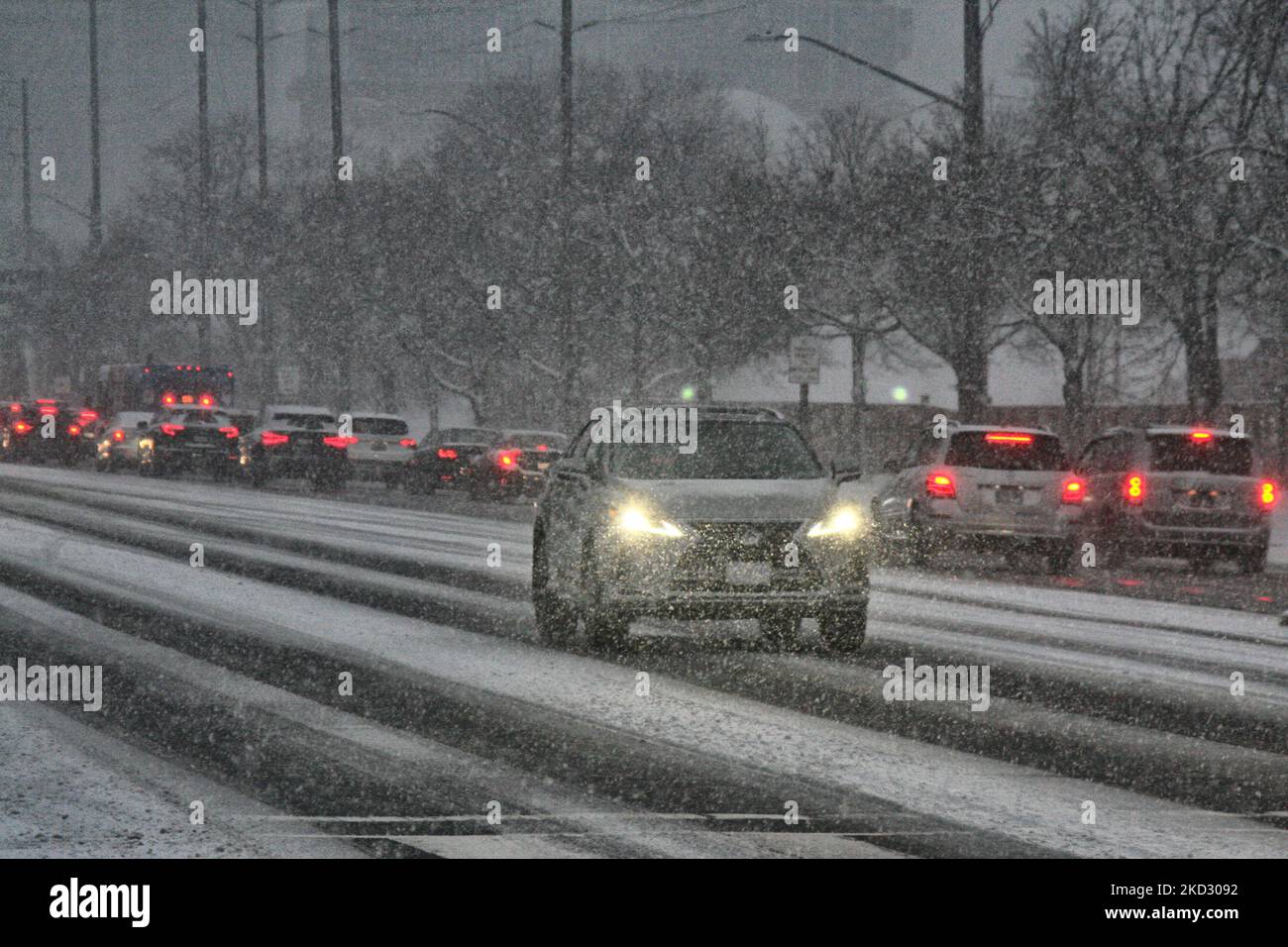 Vehicles navigate slippery roads during heavy snowfall as a Winter ...