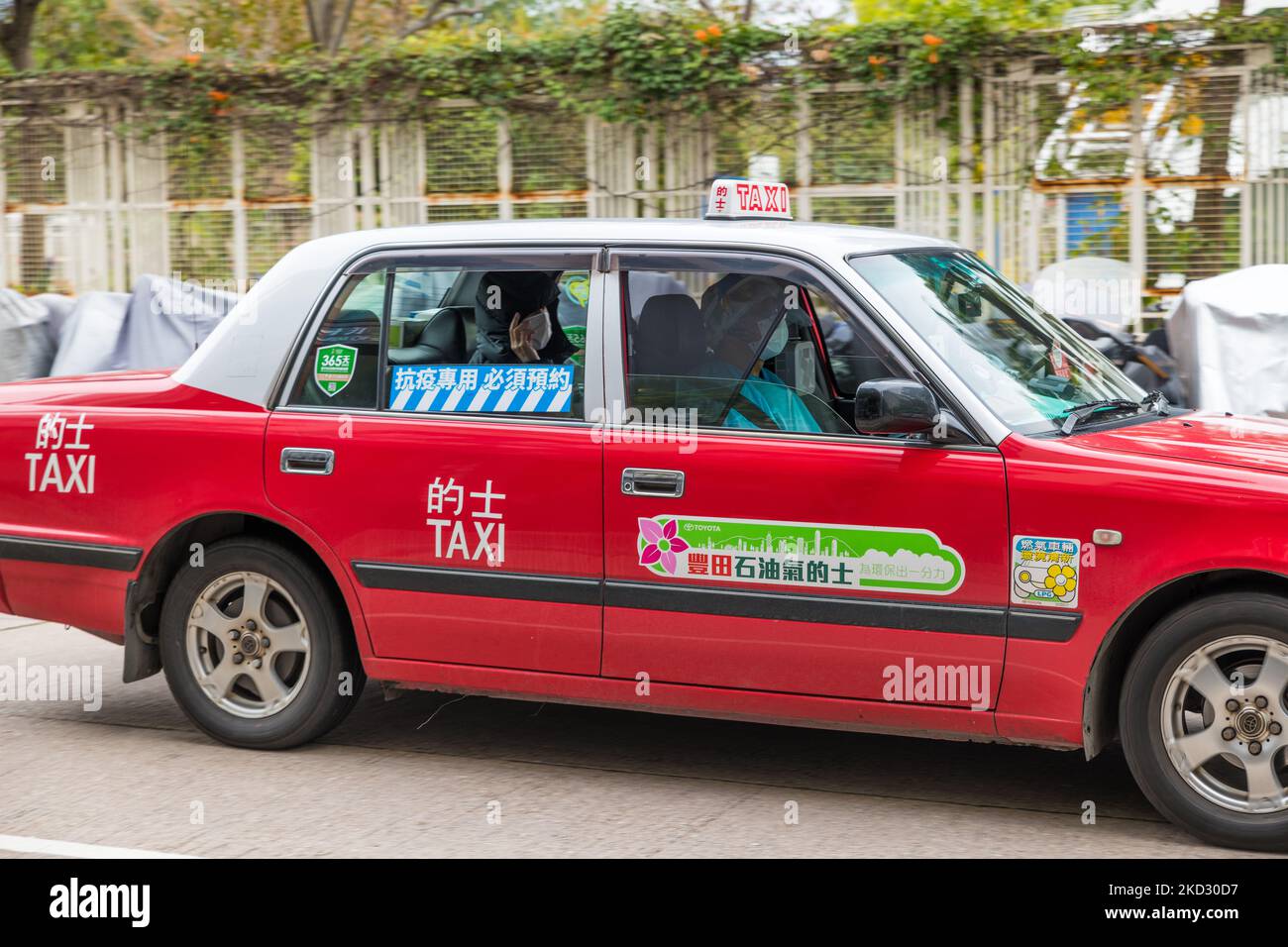 A specially designated taxi (the blue logo on the back window ...