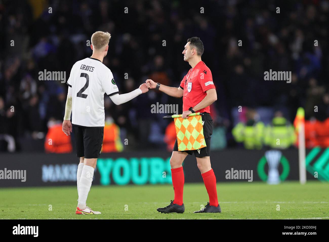 A match official fist bumps Simon Graves of Randers FC at the final ...