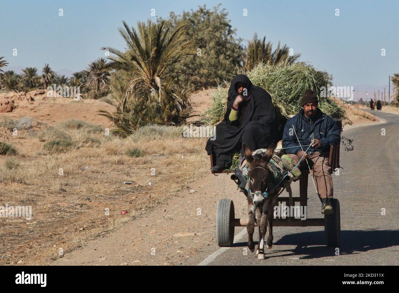 Man and his wife (who is wearing a traditional black 'haik' body cloak ...