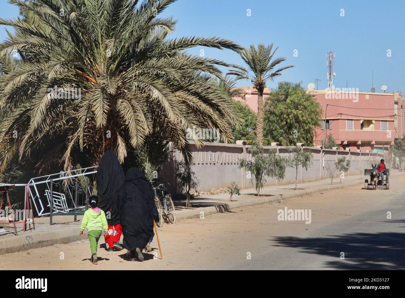 Women (who are wearing traditional black 'haik' body cloaks) in a ...