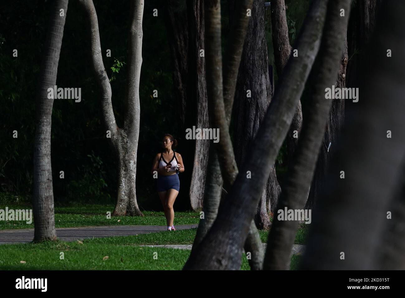 A woman jogs at a park amid the COVID-19 Omicron wave on February 19 ...