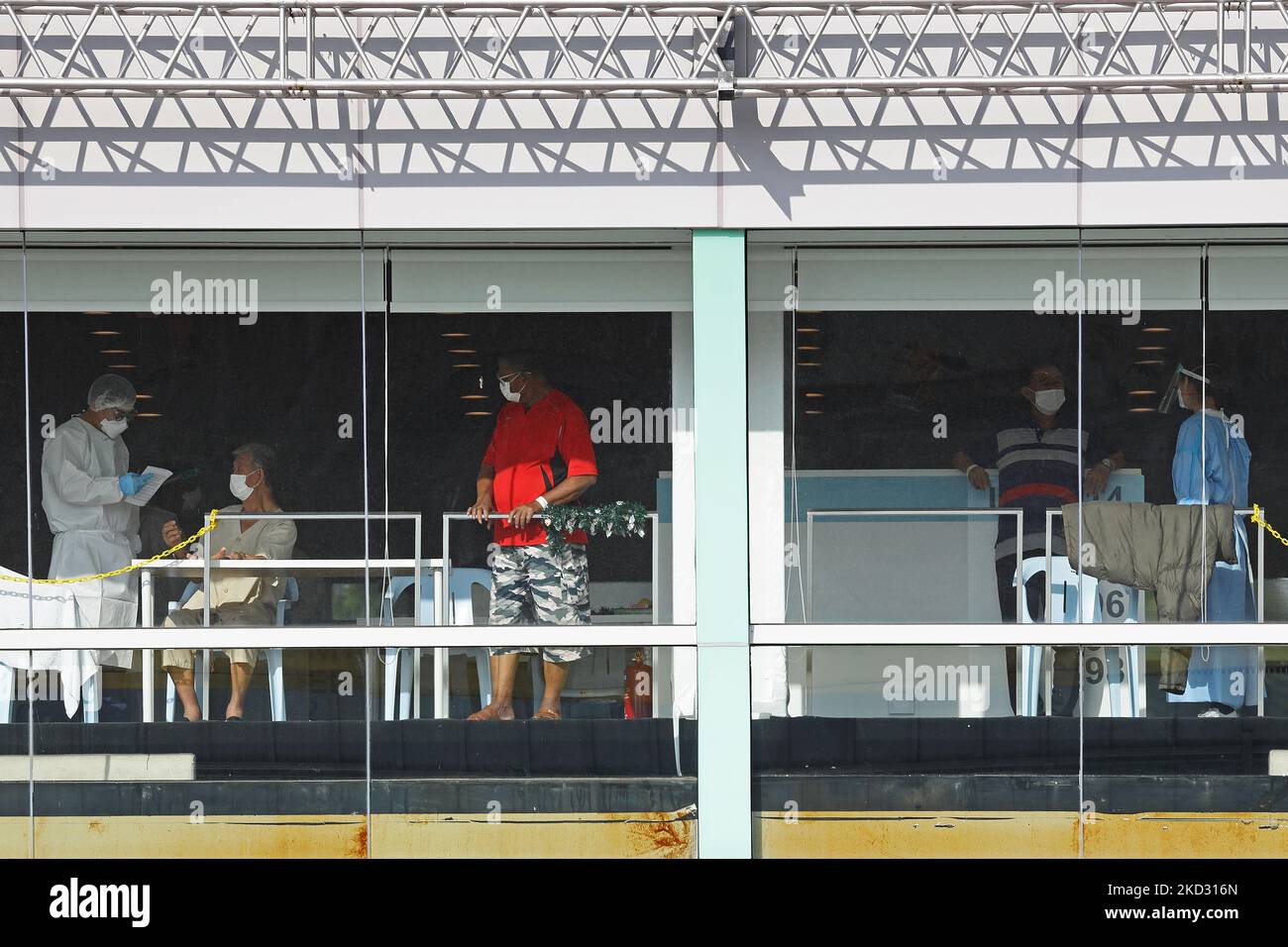 Healthcare workers dressed in personal protective equipment (PPE ...