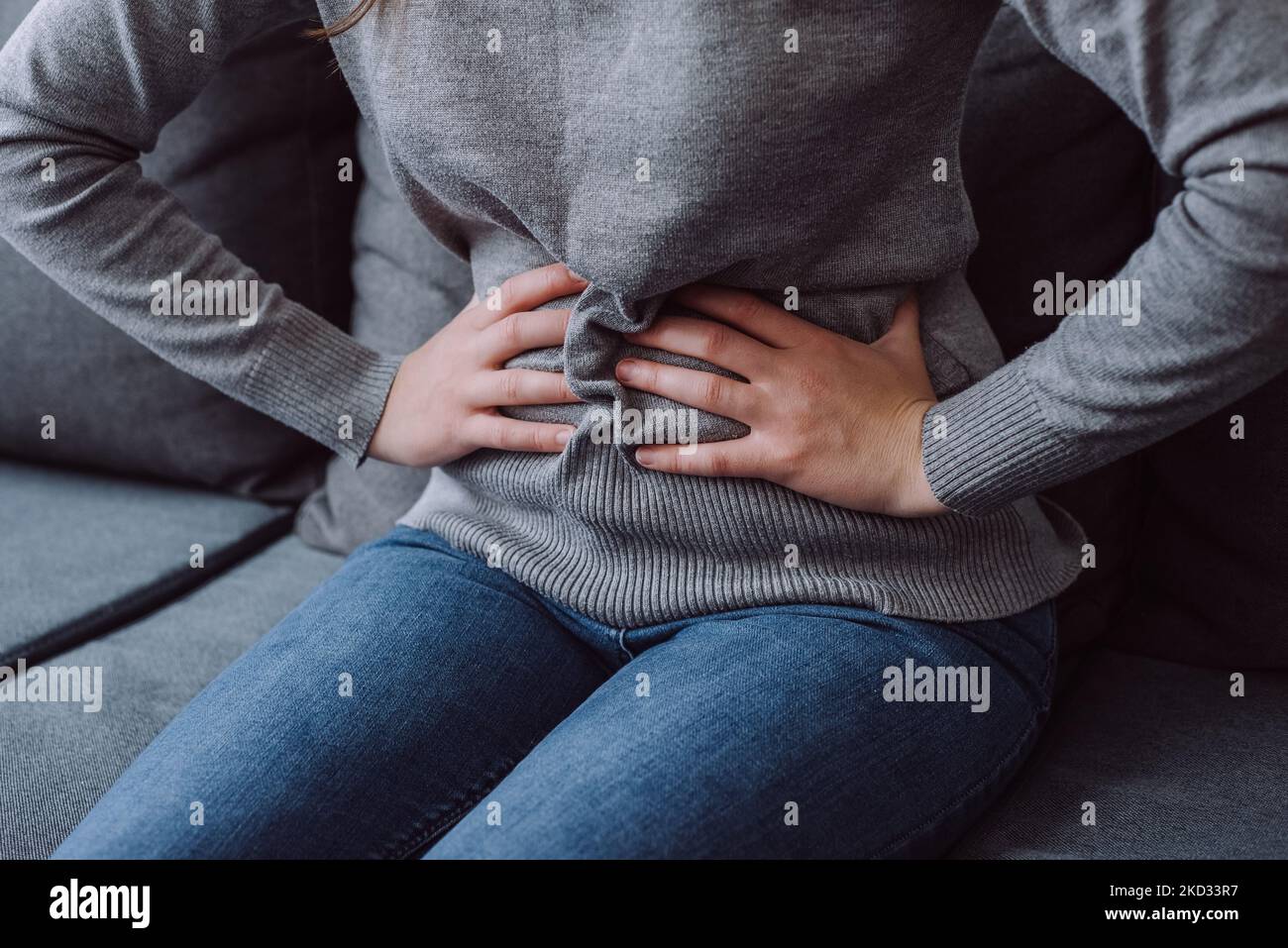 Close up of sick young female suffering stomach pain from food ...