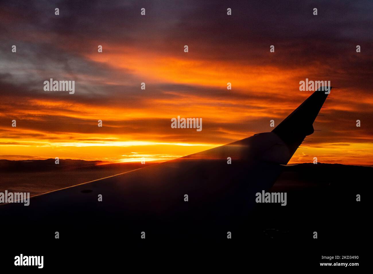 Brilliant colorful sunset behind jet plane wing from sky copy Stock ...