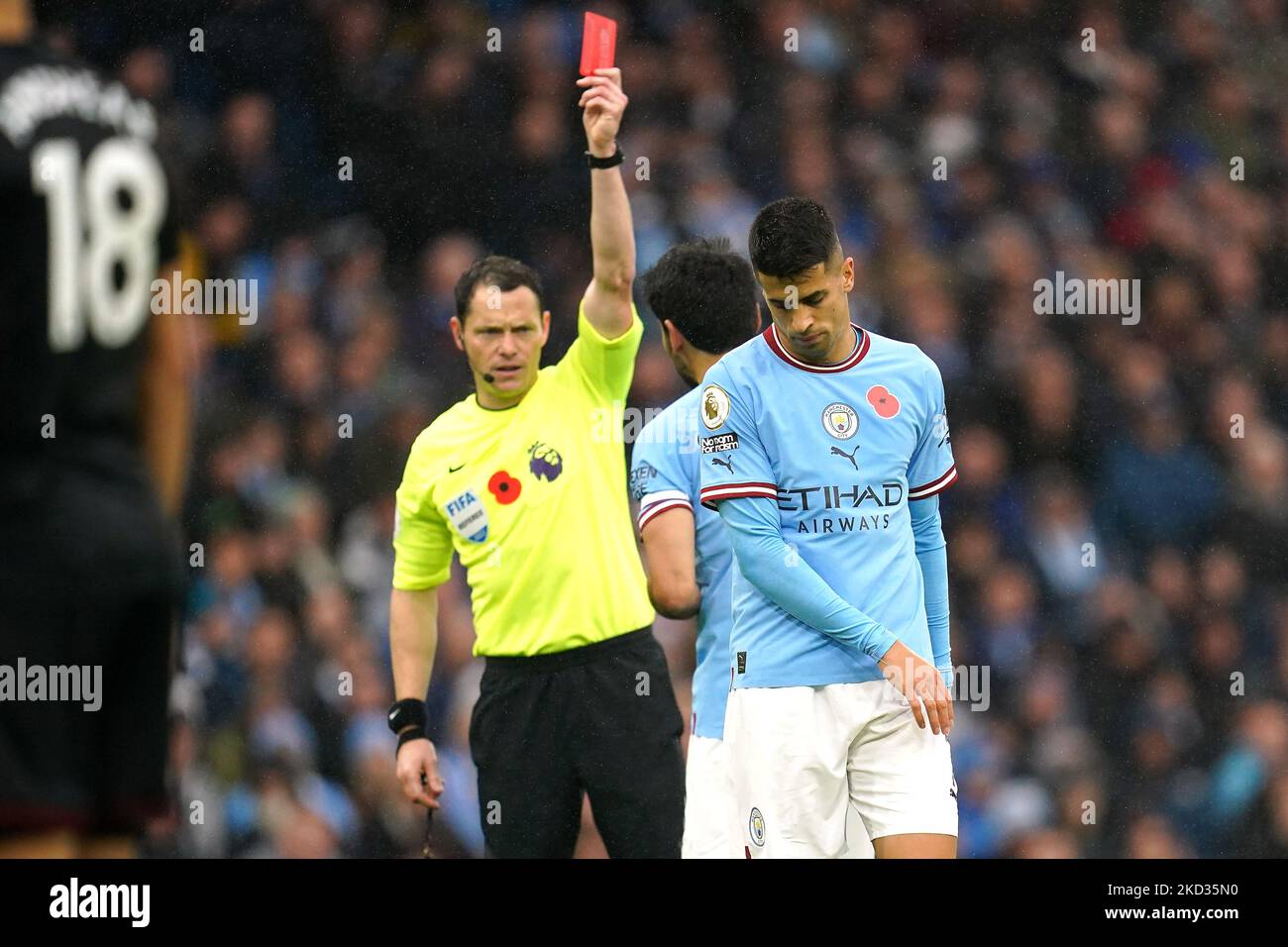 Referee Darren England (left) shows a red card to Manchester City's ...