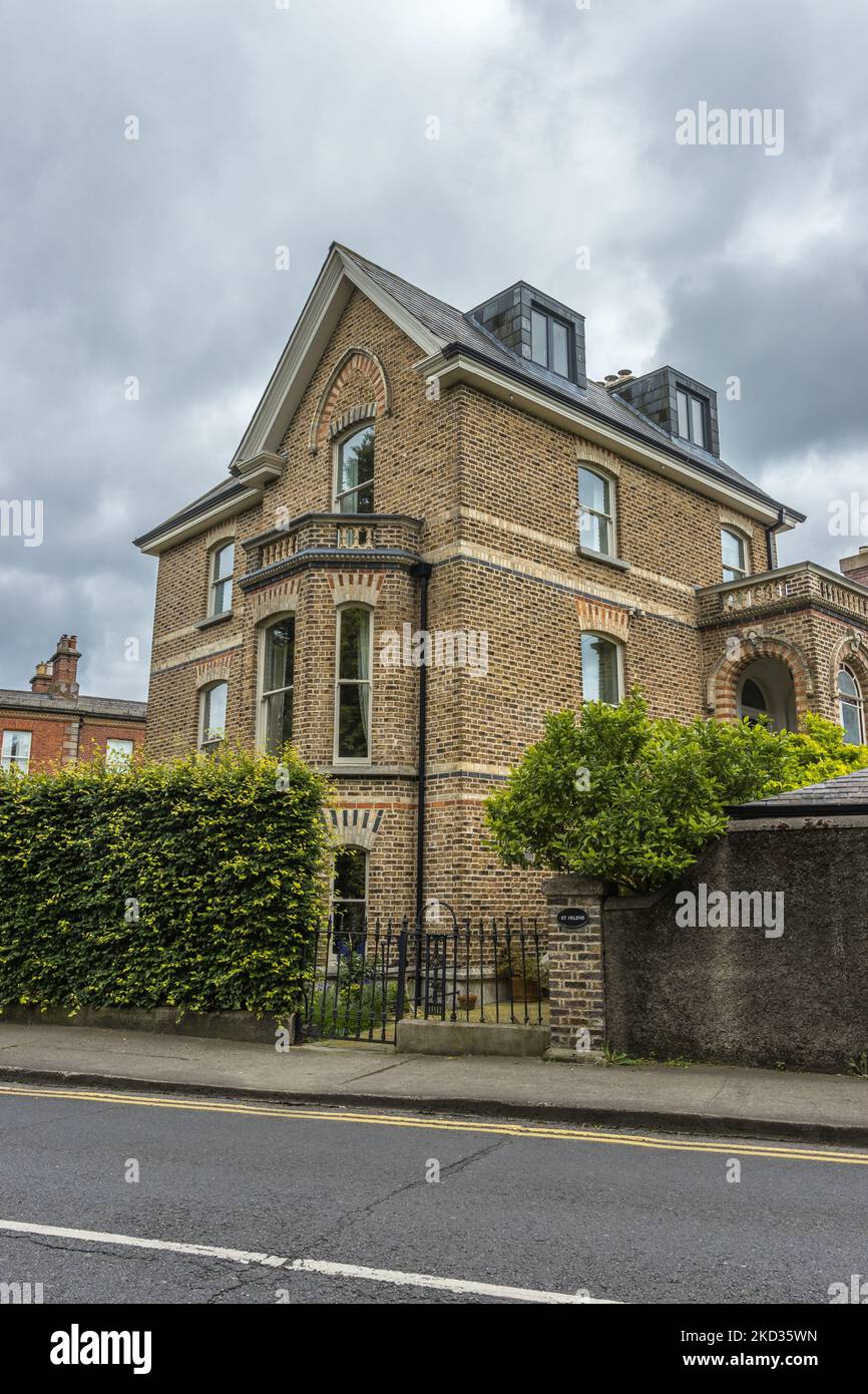 The vertical view of a street-side building with vintage brick facades ...