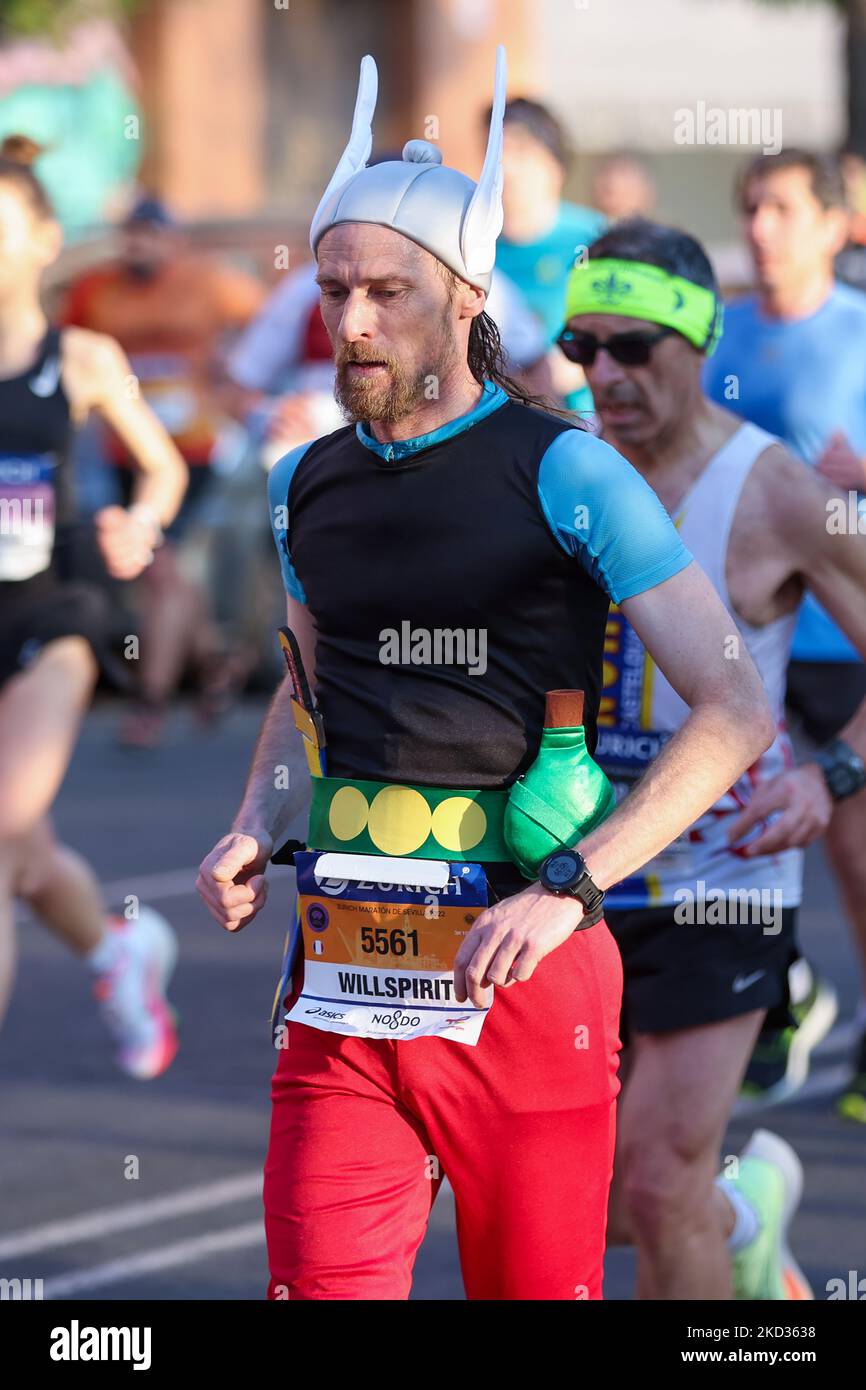 Participants run during the Zurich Seville Marathon in Seville, Spain ...