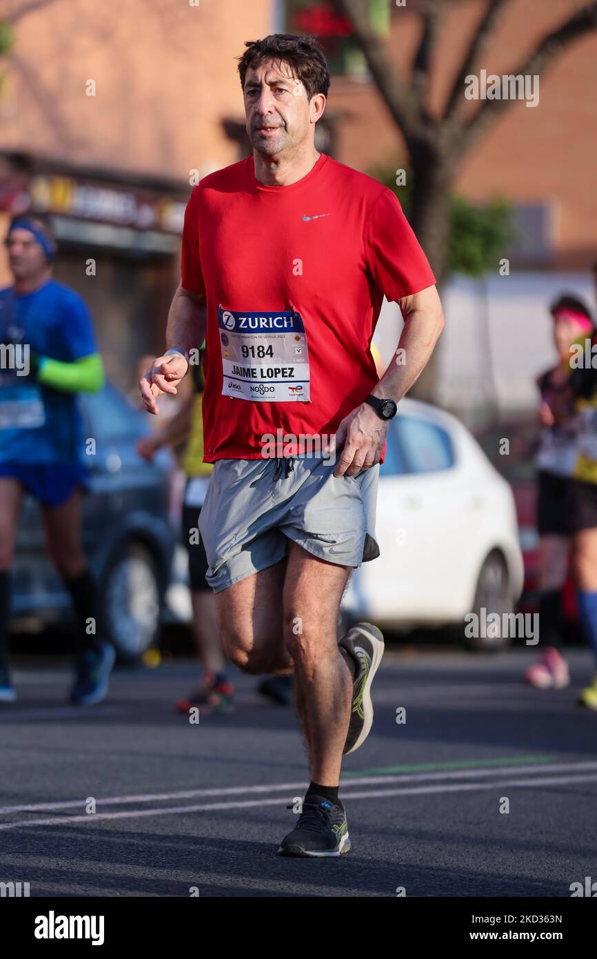 Participants run during the Zurich Seville Marathon in Seville, Spain ...