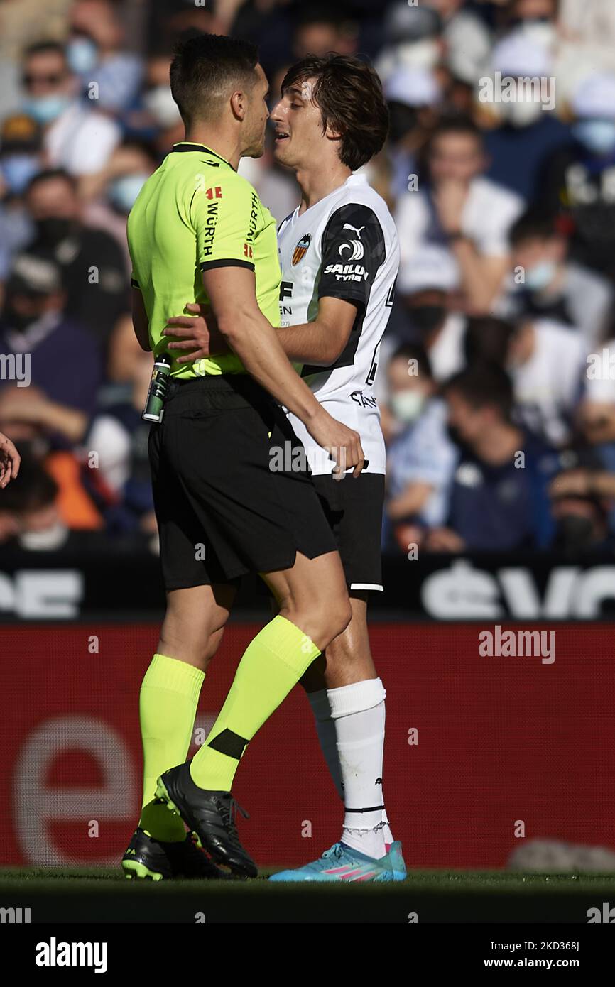 Referee Carlos Del Cerro Grande and Bryan Gil of Valencia talk during ...