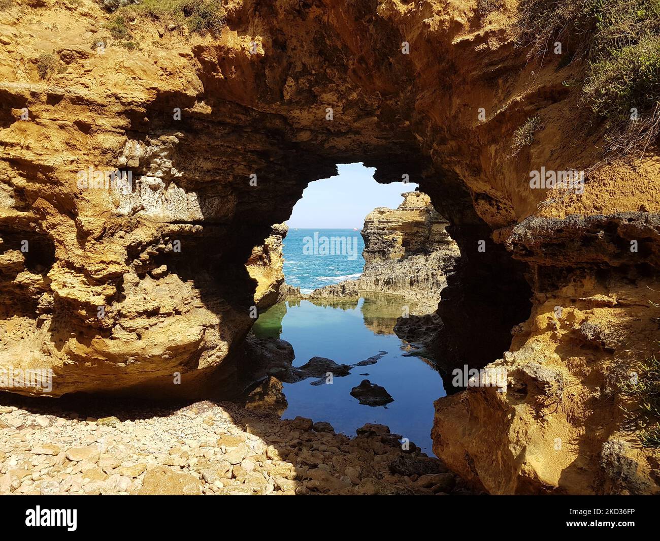 The Grotto which is is a tourist attraction with ocean and blocks Stock ...