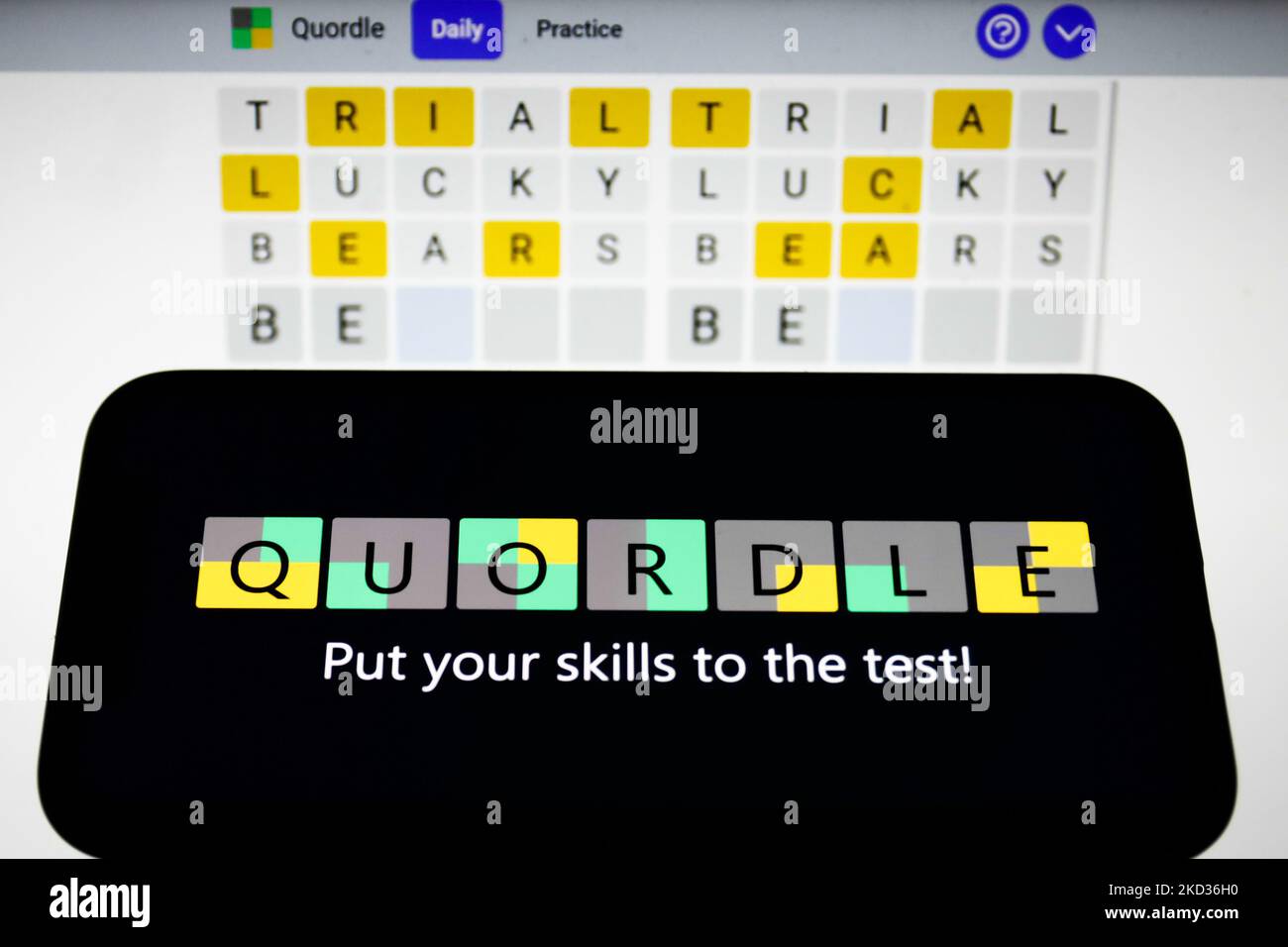 Quordle logo displayed on a phone screen and Quordle game displayed on ...