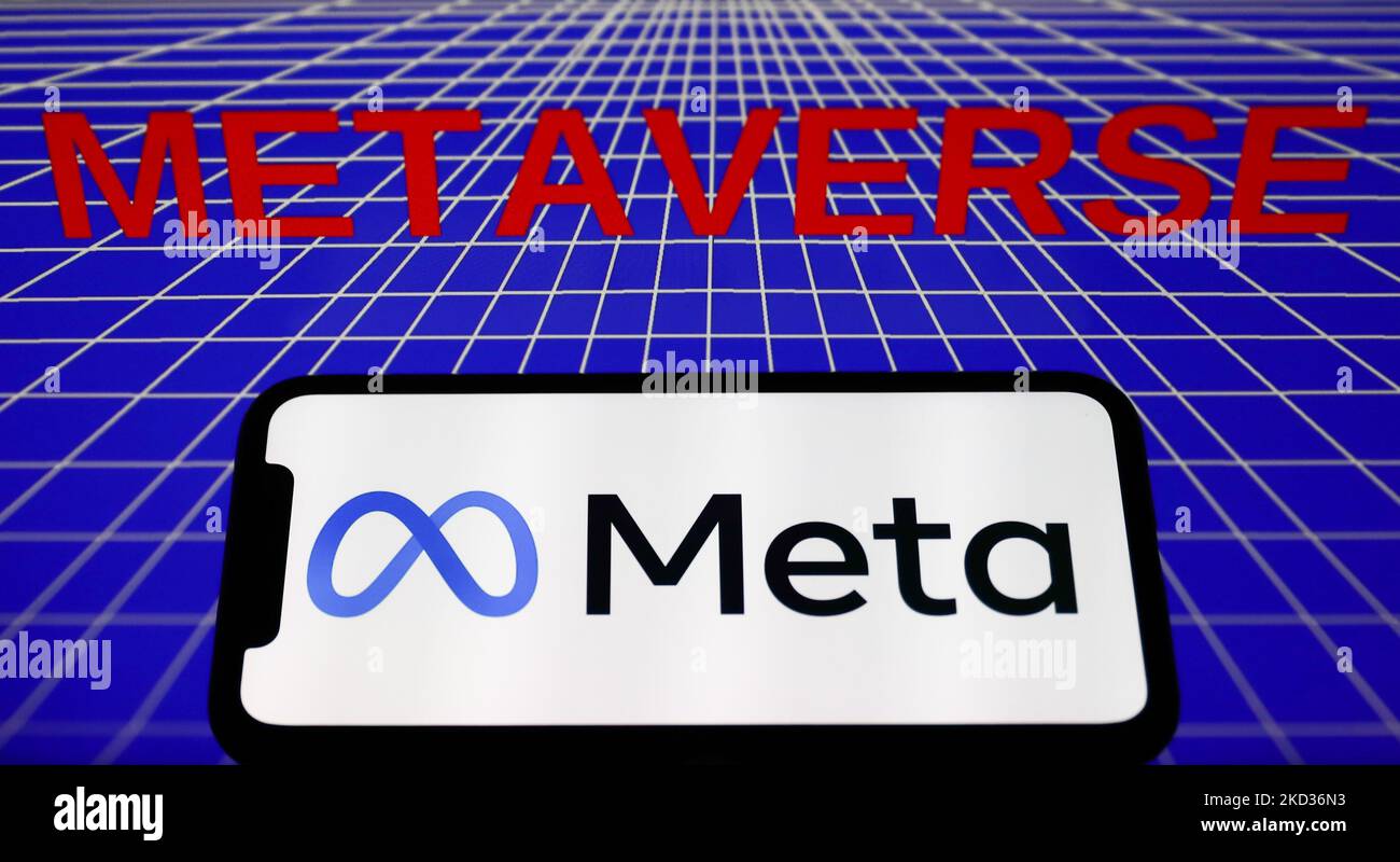Meta logo displayed on a phone screen and a 'metaverse' sign displayed ...