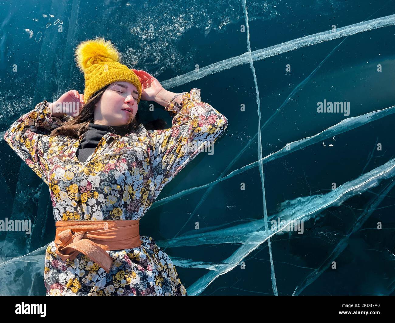 Fashionable Image Of A Stunning Woman Posing On Baikal Lake Ice Wearing Yellow Hat Boho Dress