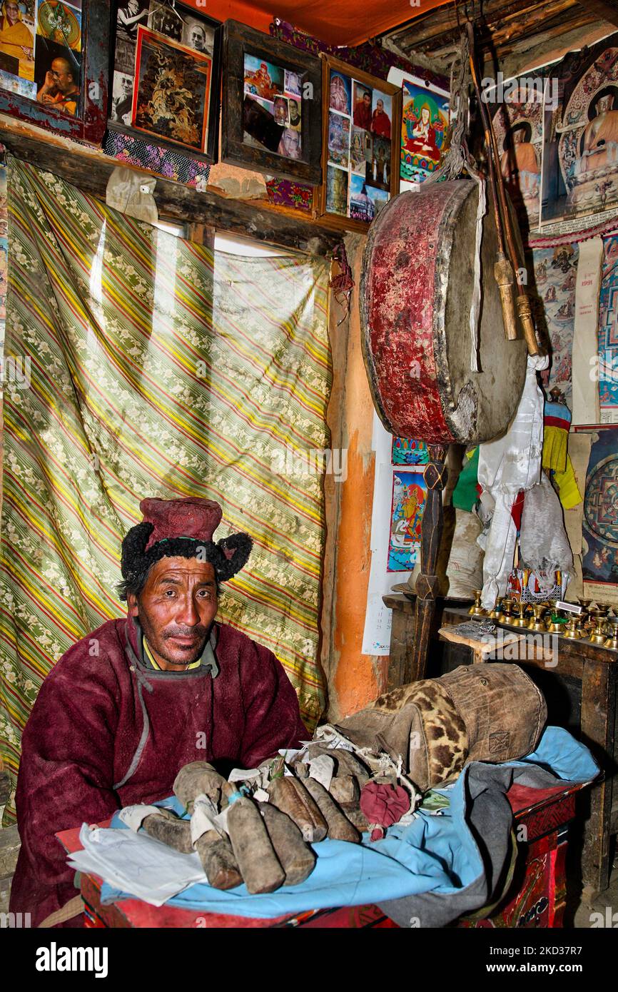 A Ladakhi Amchi (a traditional Ladakhi doctor) sits with his bags of ...