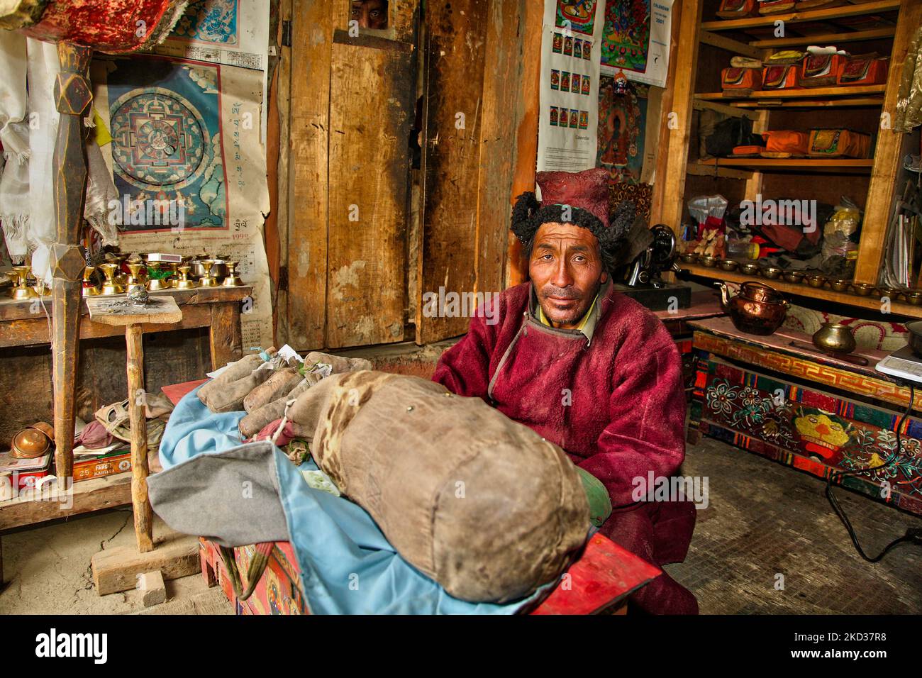 A Ladakhi Amchi (a traditional Ladakhi doctor) sits with his bags of ...