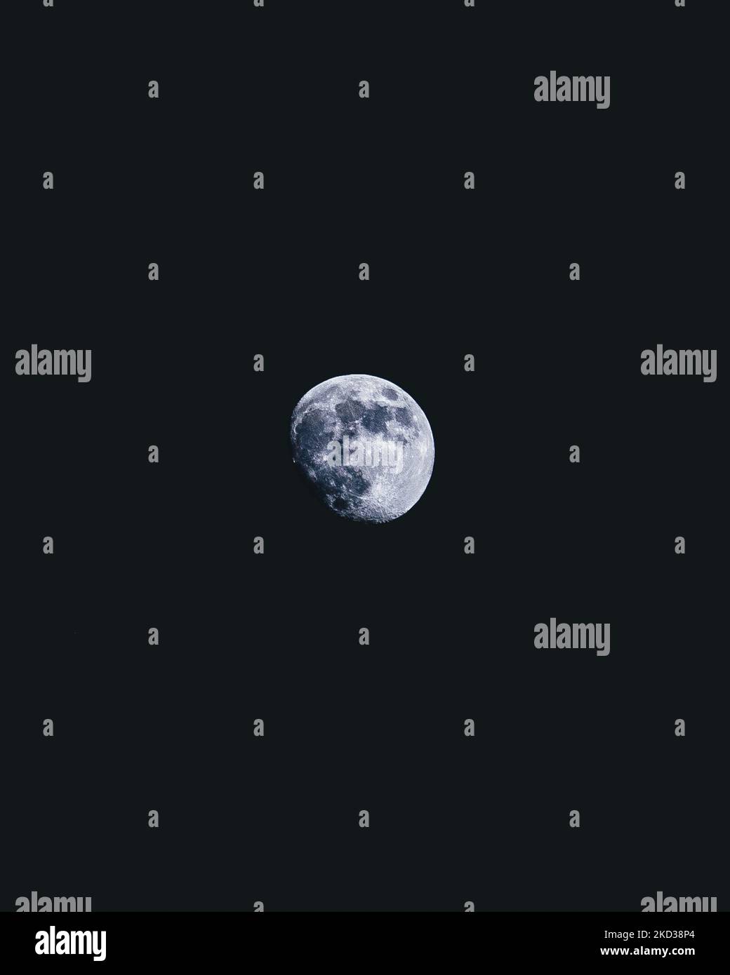 A vertical image of nearly full moon in the night sky Stock Photo - Alamy