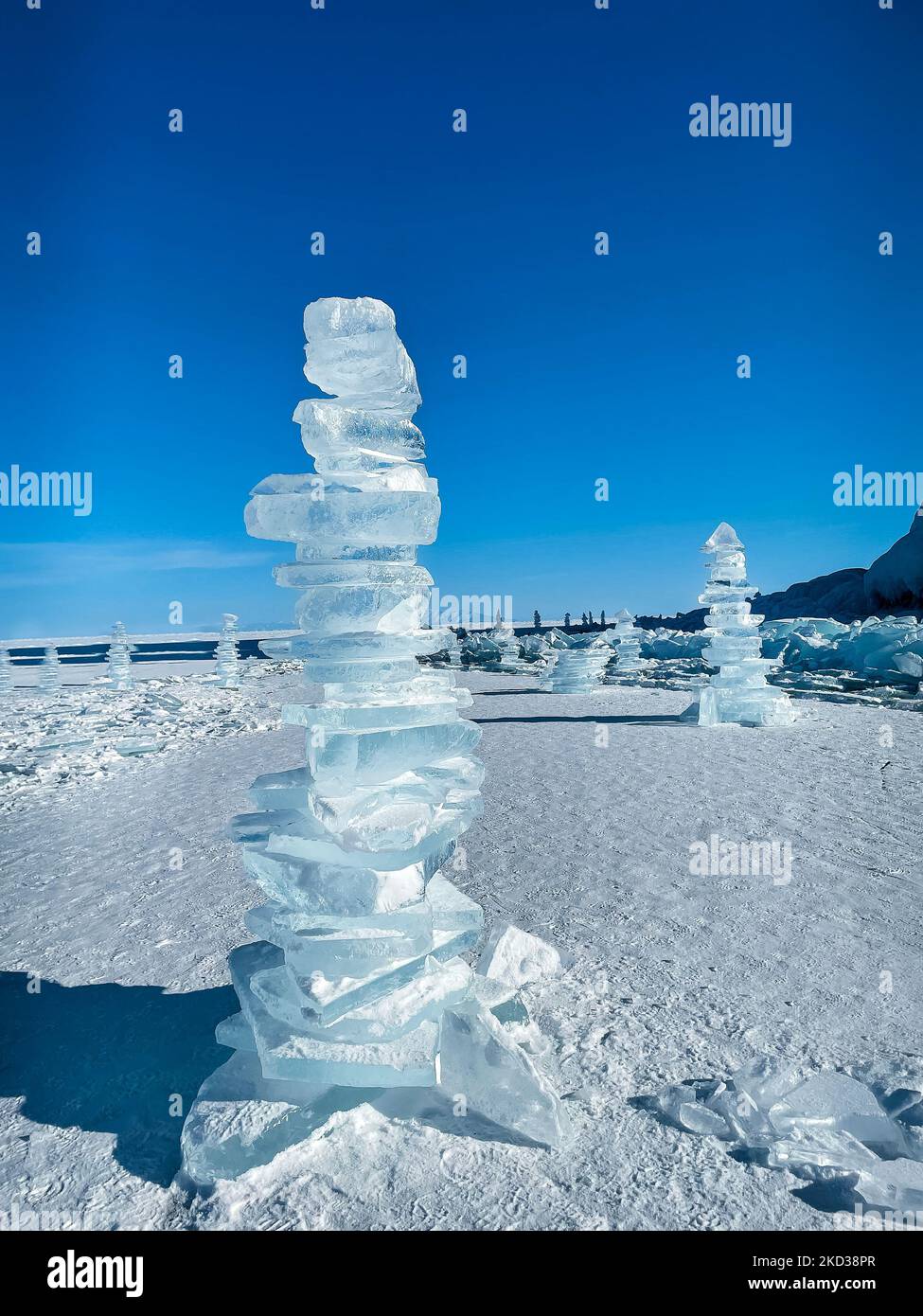 Pieces of ice lying on the ideal smooth ice of baikal with ice hummocks ...