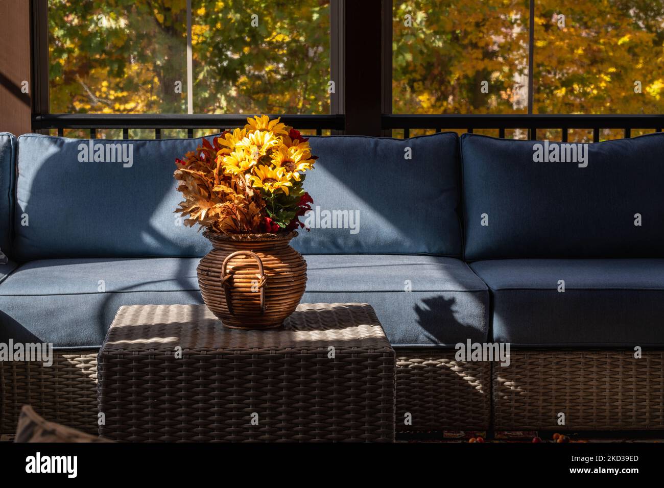 Cozy screened porch enclosure view in autumn. Flower bouquet in a vase ...