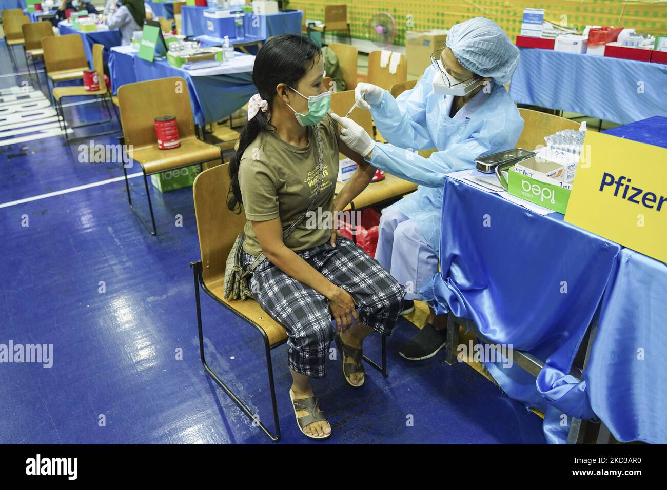 People receive doses of the Pfizer COVID-19 vaccine at a vaccination ...